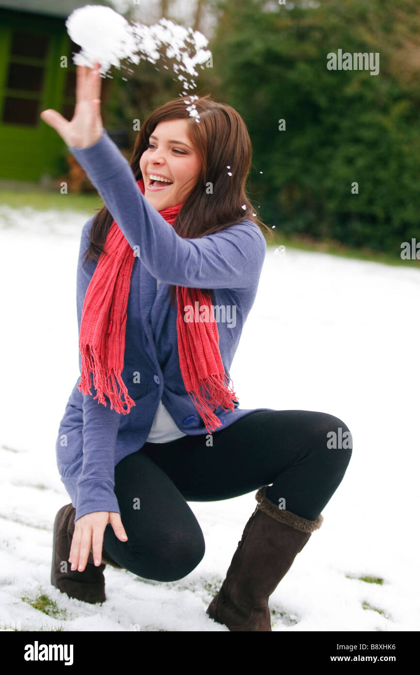Girl throwing snowballs Stock Photo - Alamy