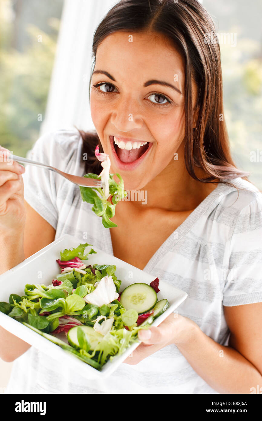 Girl eating salad Stock Photo - Alamy