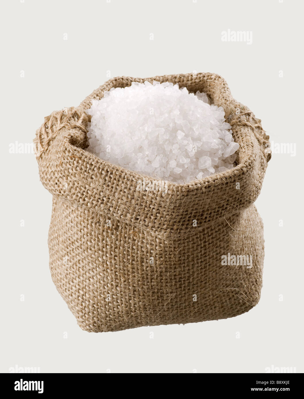 Sea salt in a burlap sack isolated on white Stock Photo - Alamy