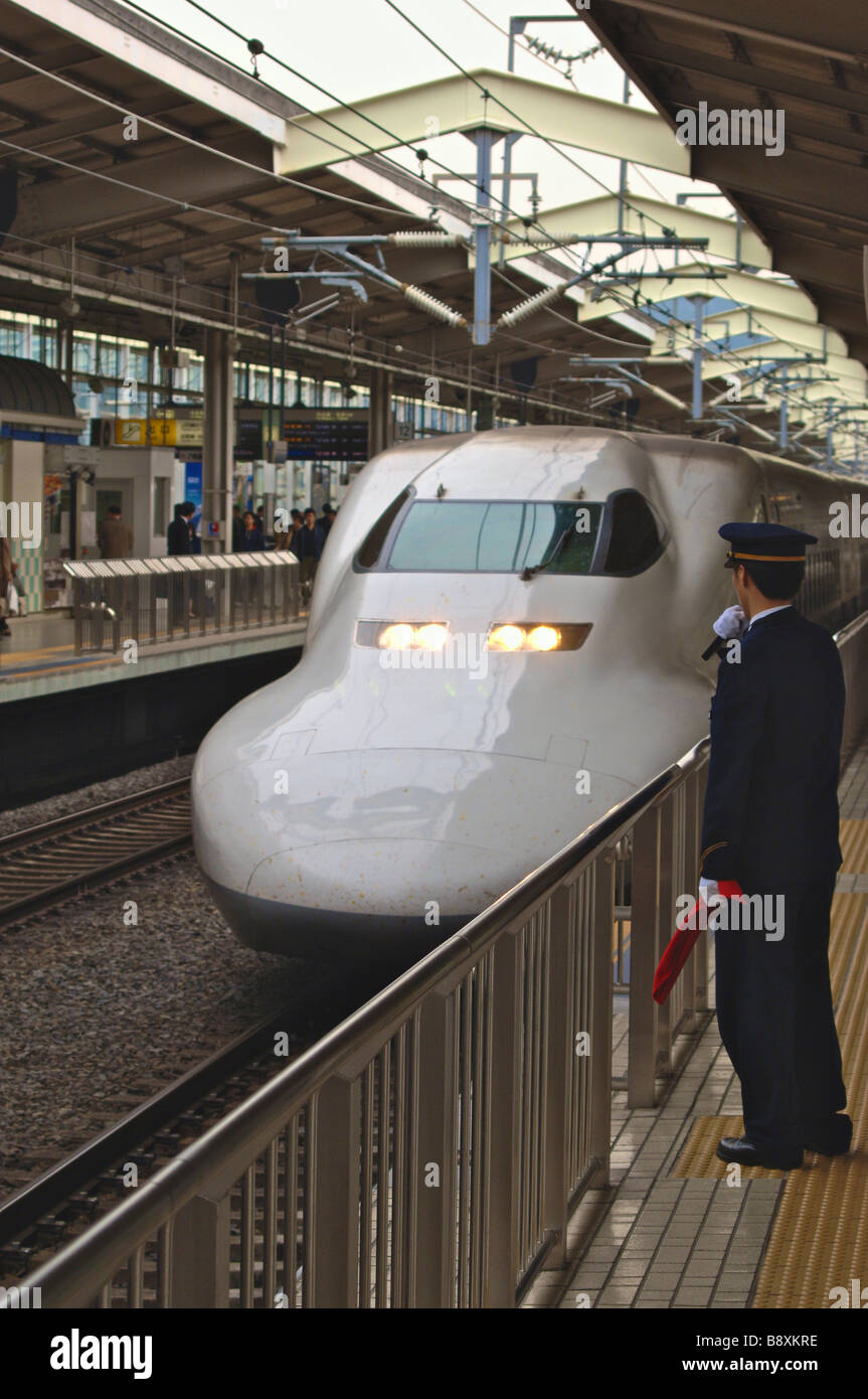 Platform Guard at Kyoto Station signalling the arrival of the ...