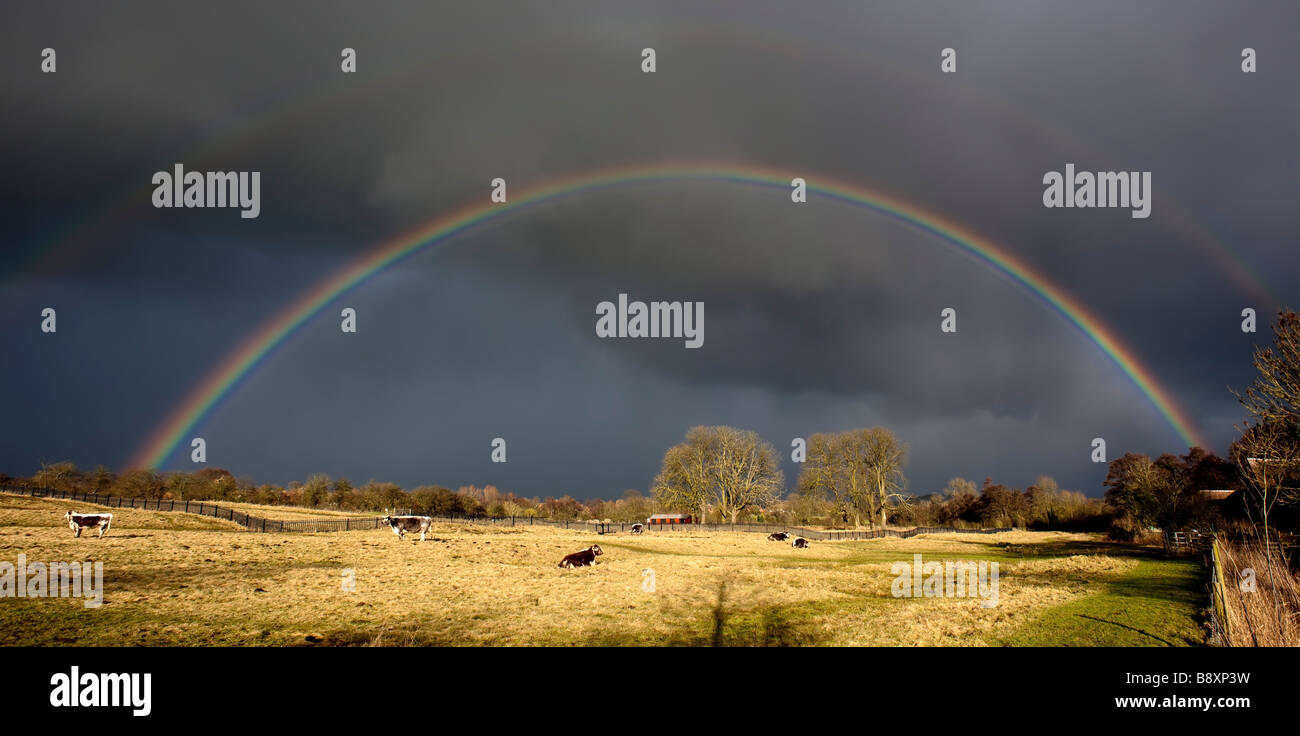 a rainbow over farmland Stock Photo - Alamy