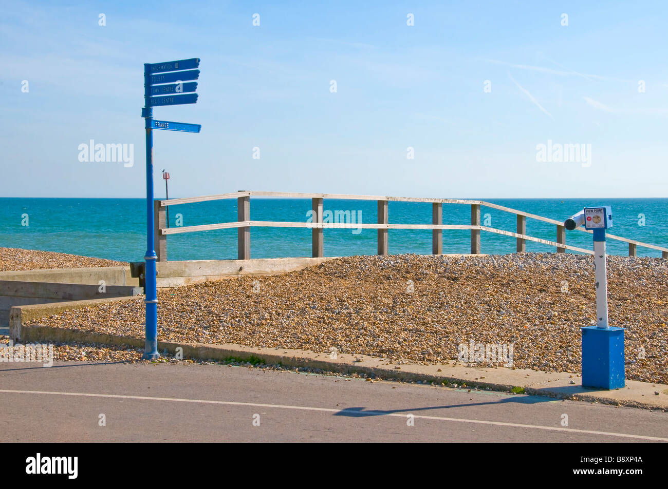 Seaside signs and telescope across the sea Stock Photo - Alamy