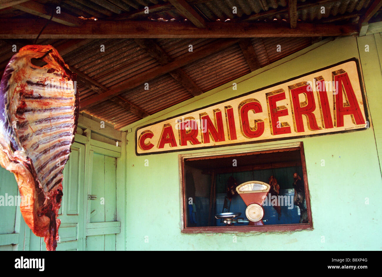 A rustic butcher shop in Curuguaty, Paraguay, featuring a hanging rib ...