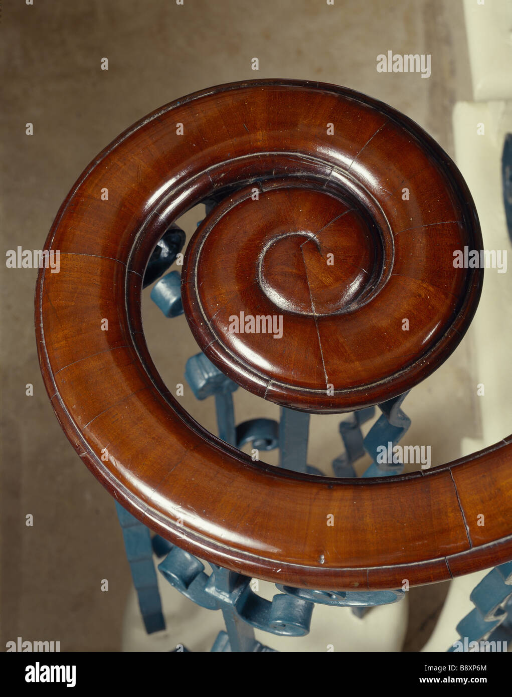 Detail of curved vortex shaped wooden banister end at bottom of ...