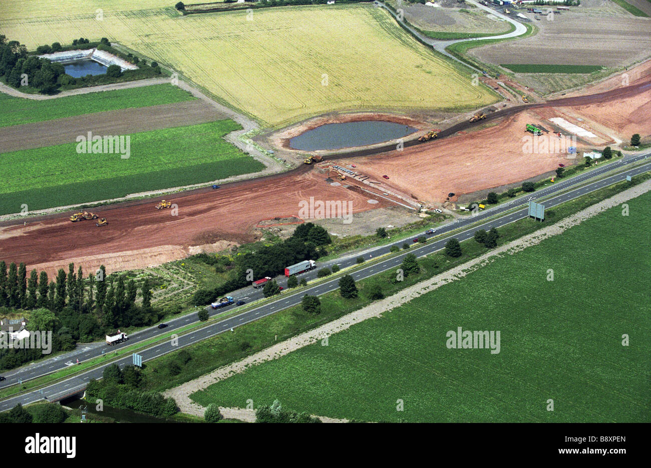 Aerial view of the M6 Toll Road motorway under construction next to the ...