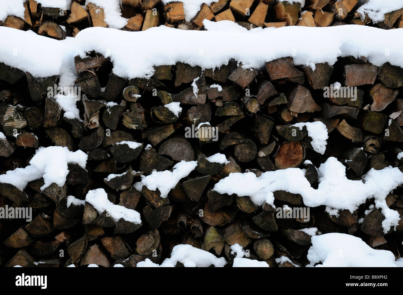 snow covered firewood wood log pile stockpile during winter Stock Photo ...