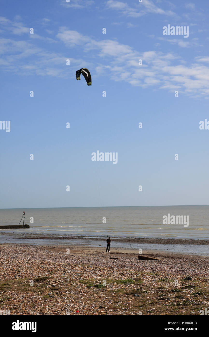 person flying a surfing kite on a beach Stock Photo - Alamy