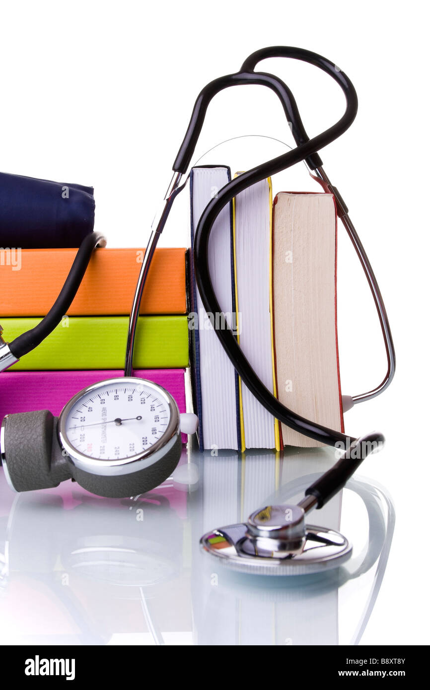medical equipment and a stack of books isolated on white selective ...