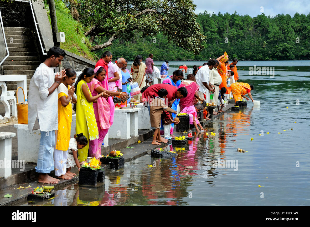 Mauritian family making a offering at a religious ceremony, Grand ...