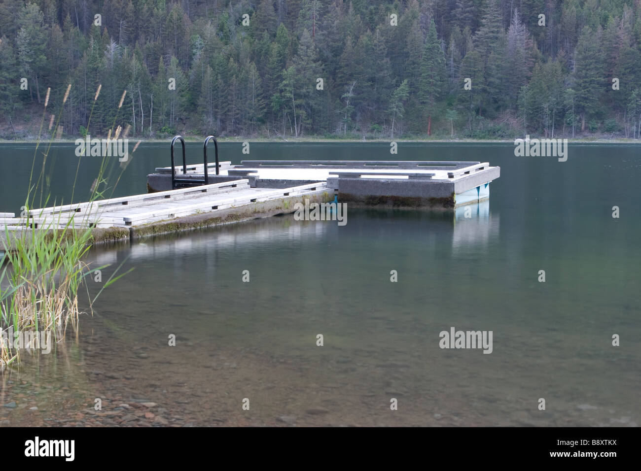 Warf on a calm lake Stock Photo - Alamy