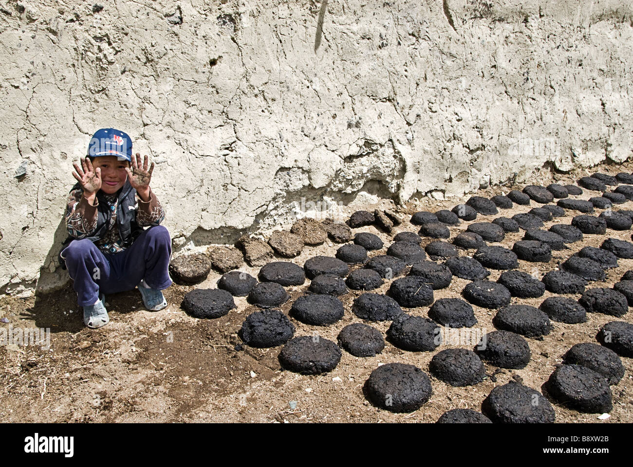 Kids drying excrements on the sun, Pamir highway, Tajikistan, Asia ...