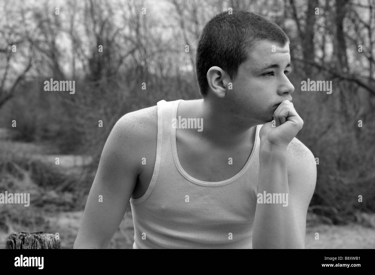 A teenage boy stares off into the distance and thinks Stock Photo - Alamy