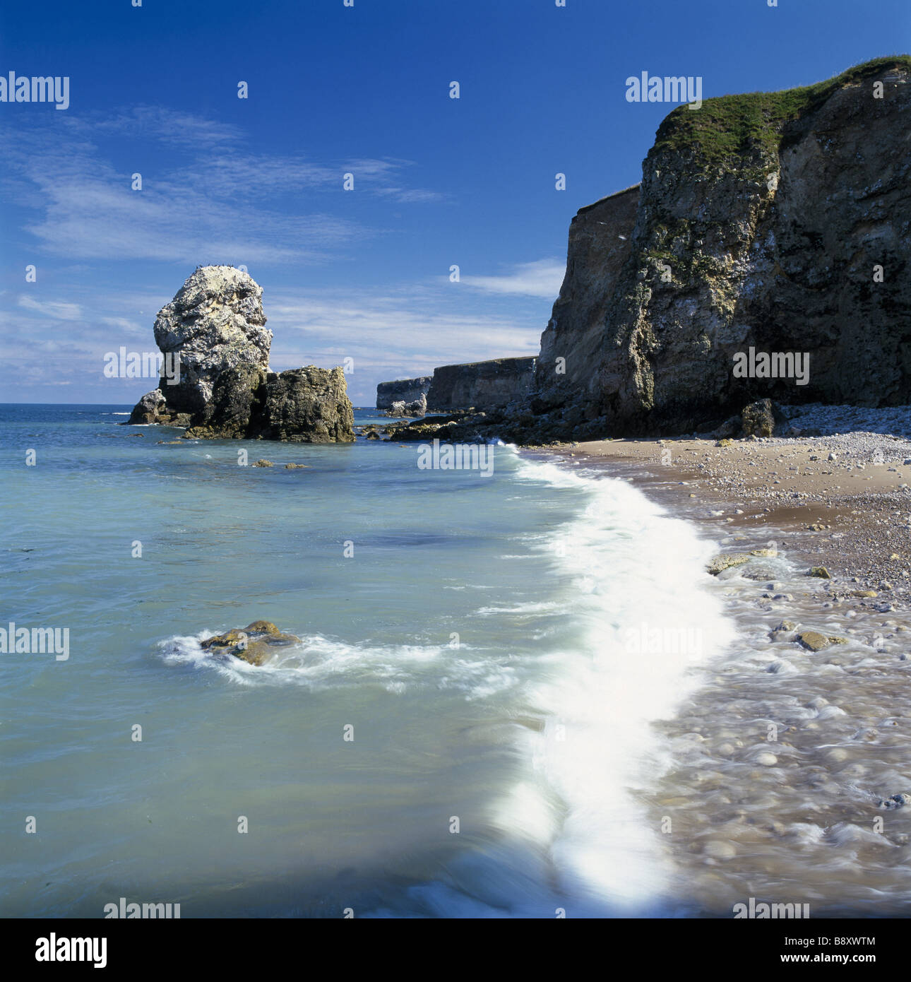 A view along the rugged shoreline of Marsden Bay a gentle surf breaks ...