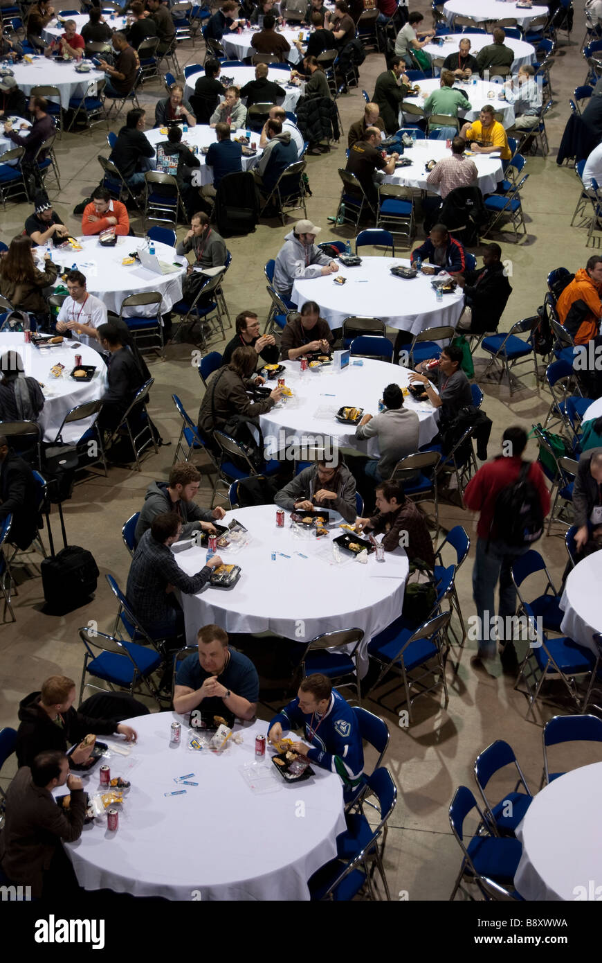 Rows of round tables with people eating lunch Stock Photo - Alamy
