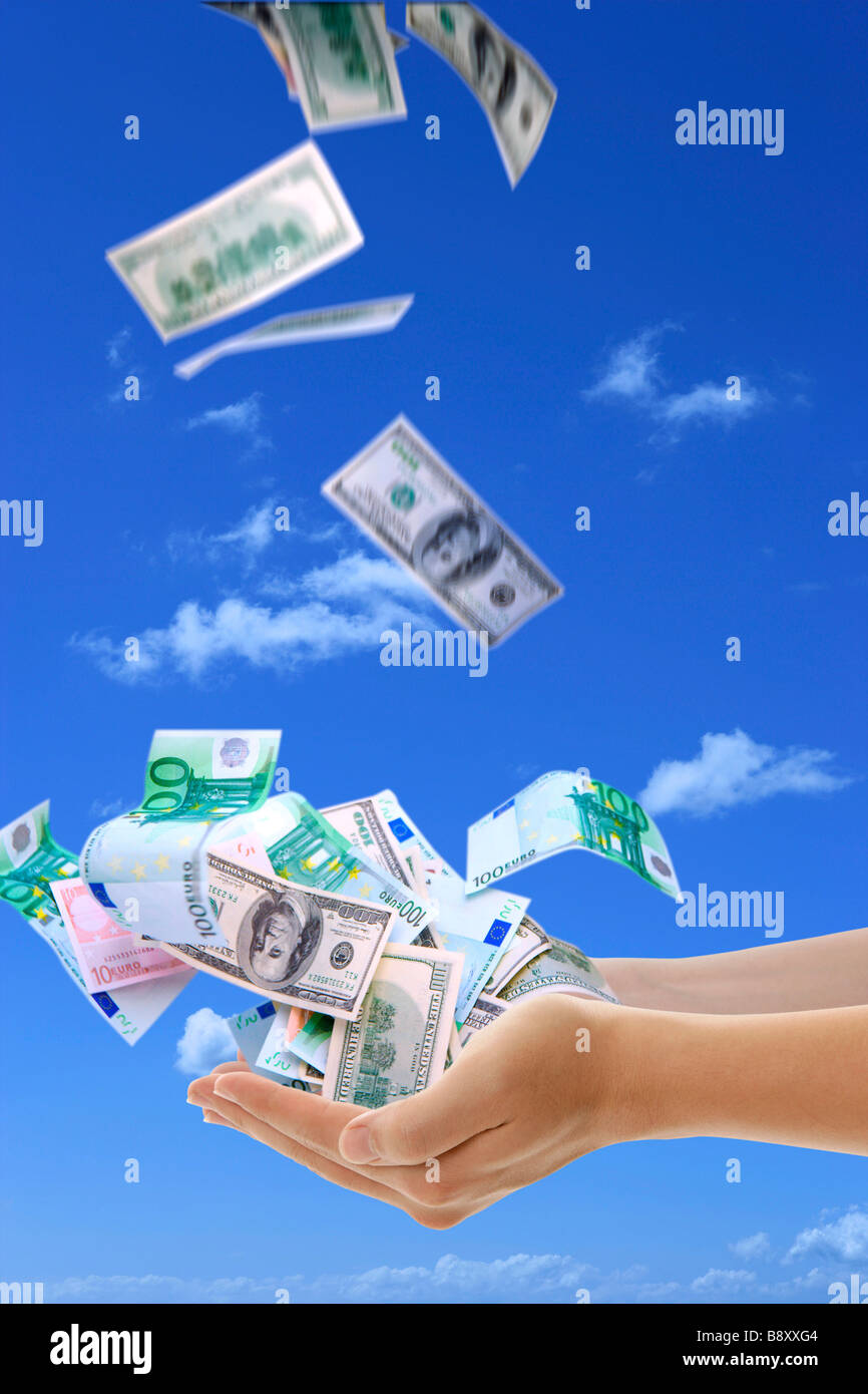 Two hands cupping paper money falling from heaven Stock Photo - Alamy