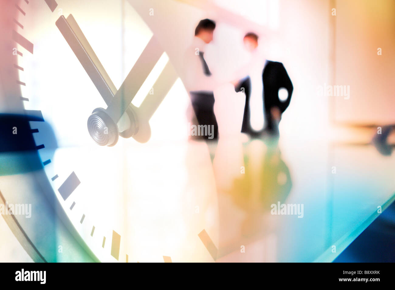 Two people talking together composite with the clock Stock Photo - Alamy
