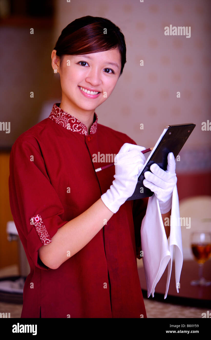 Young waitress writing menu and smiling at the camera Stock Photo - Alamy