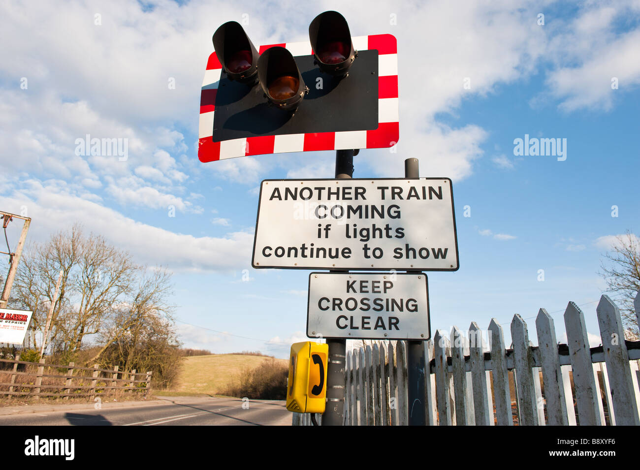 Railway crossing at the junction of a train track and road. Kirkby In ...