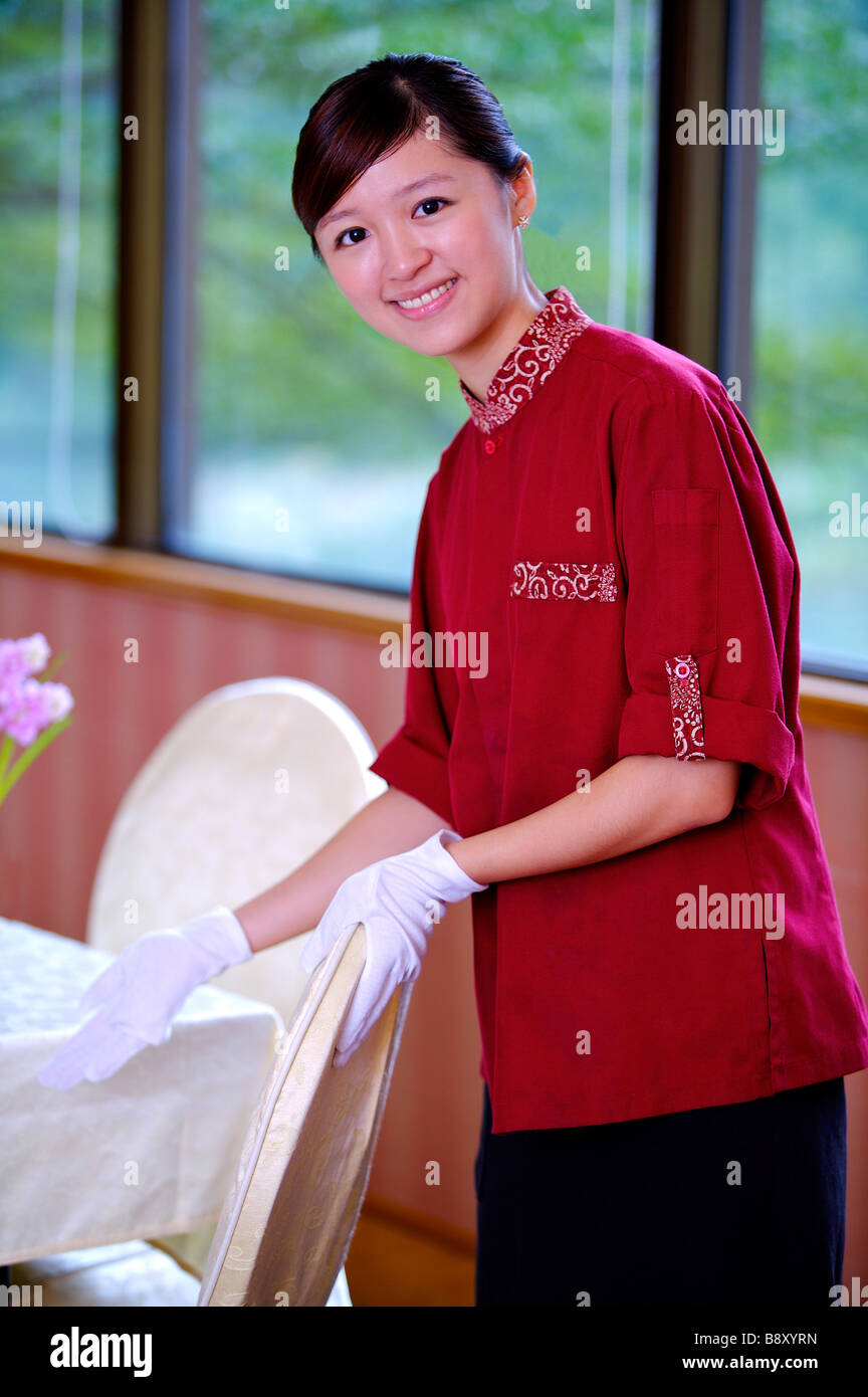 Smiling waitress setting table hi-res stock photography and images - Alamy