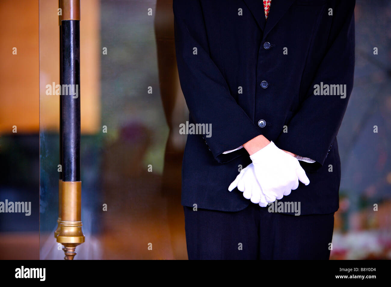 Young woman standing with hands folded in front Stock Photo - Alamy