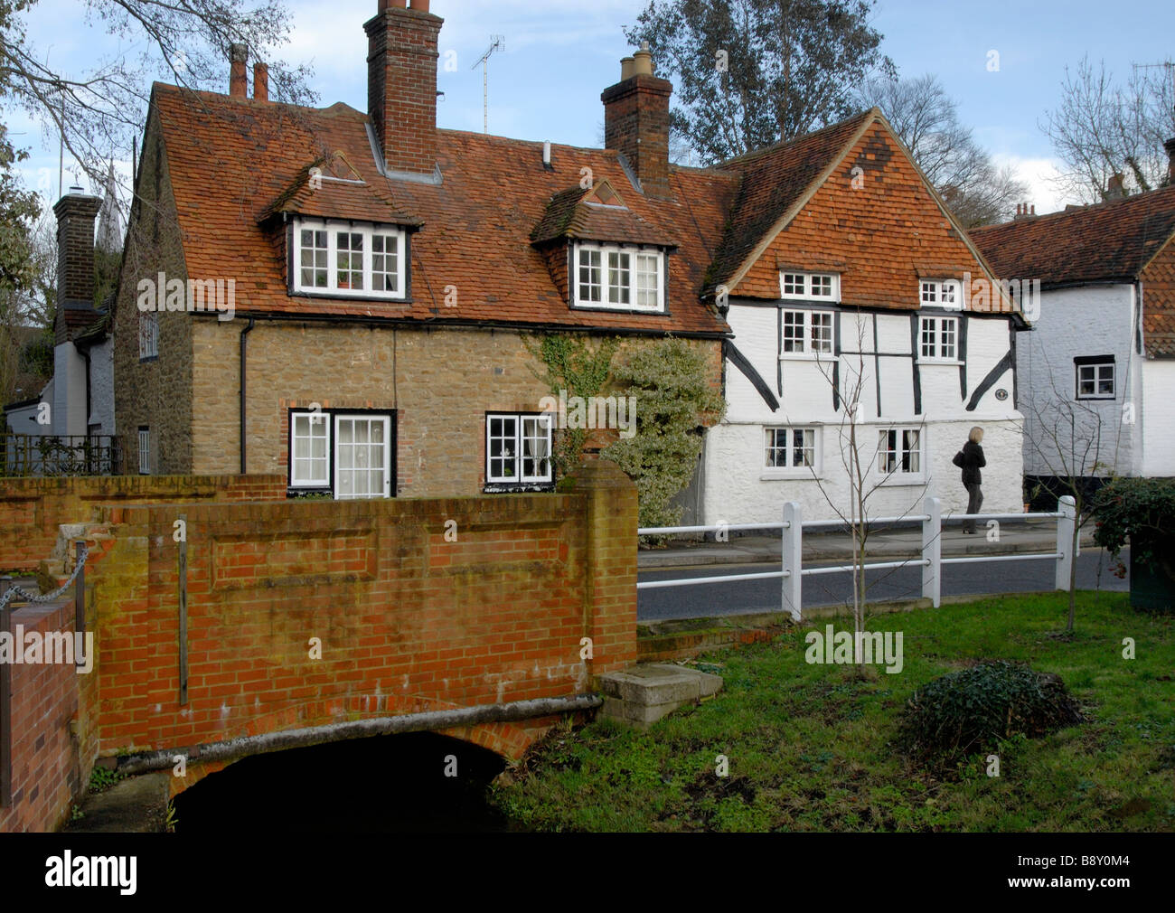 16th and 17th century cottages, bridge over River Ock and young woman ...