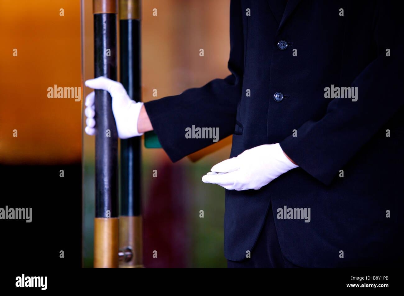 Young man holding handle and wearing white glove Stock Photo - Alamy