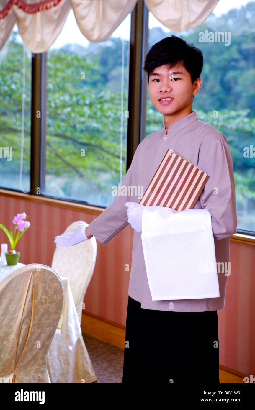 Well dressed waiter holding menu hi-res stock photography and images ...