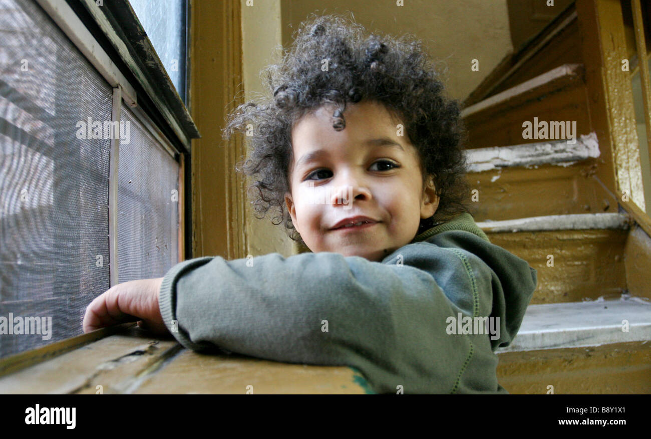 Boy smiling near a window sill Stock Photo - Alamy
