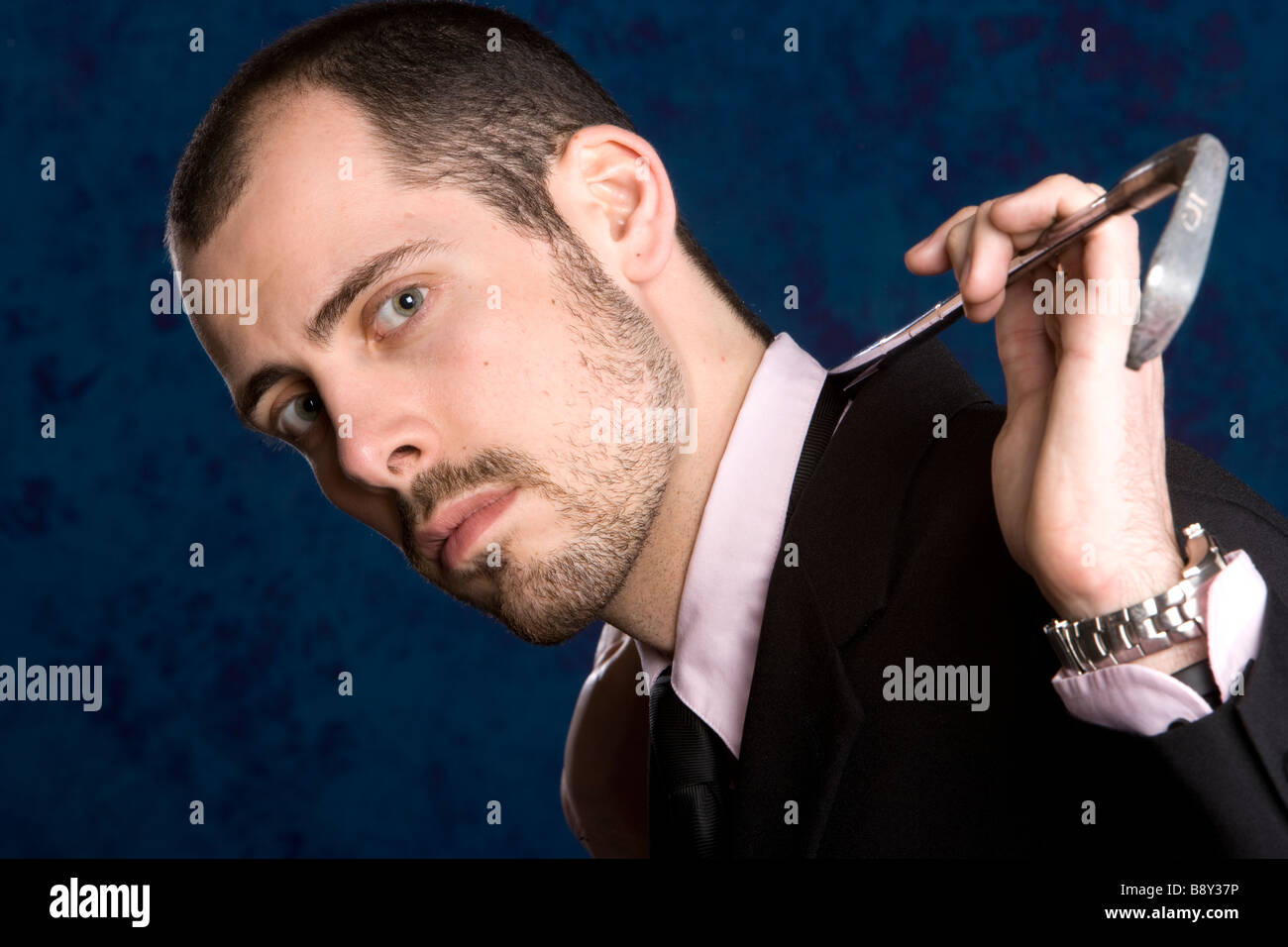 man looking menacing at camera against blue background Stock Photo - Alamy