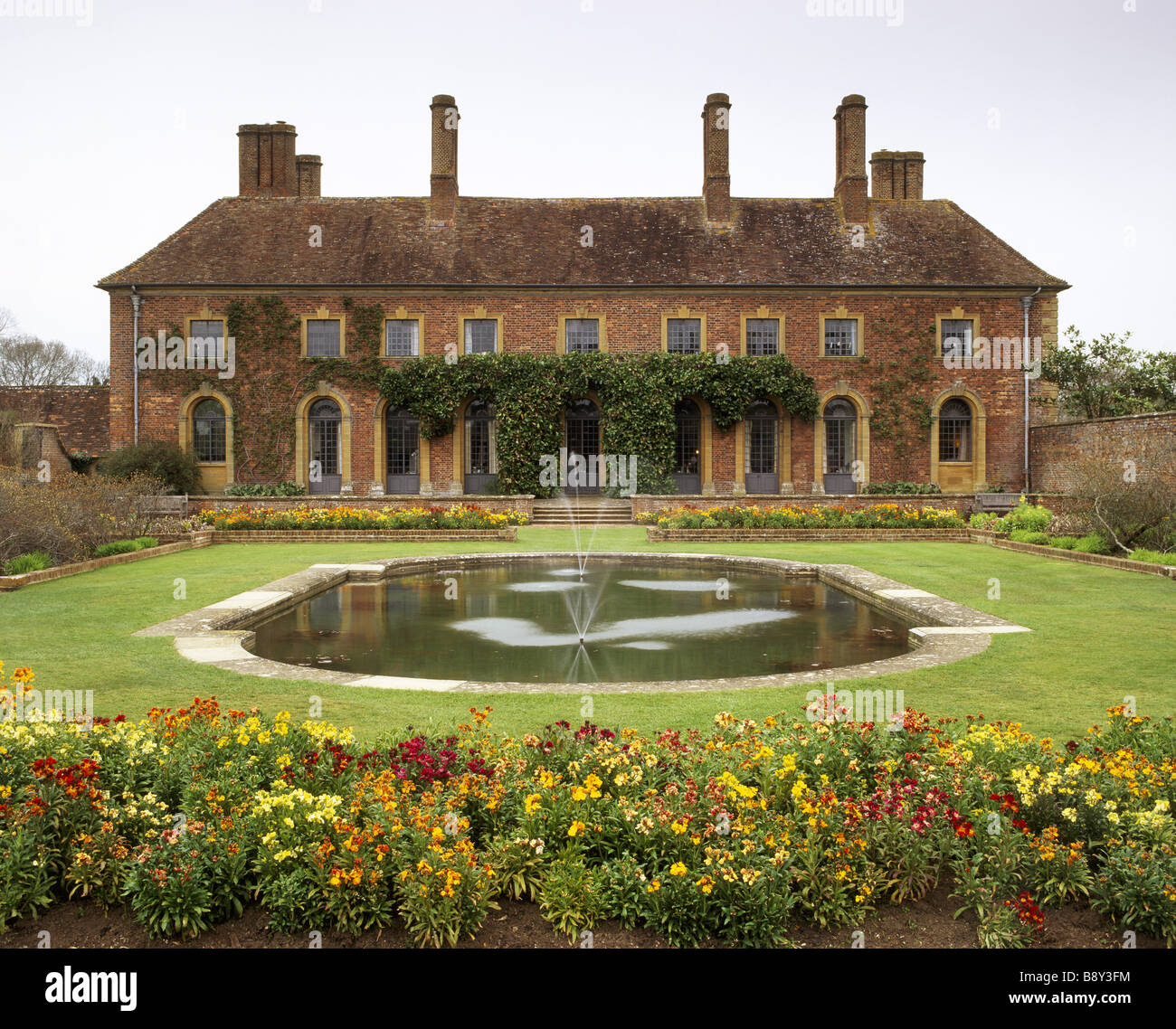 West aspect of Barrington court with Lily pond garden and Wallflowers ...