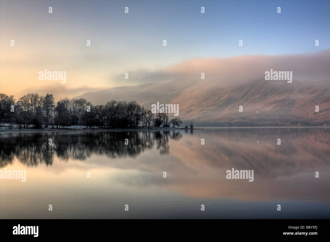 Taken early in the morning the early rays of sun catch the fells on the ...