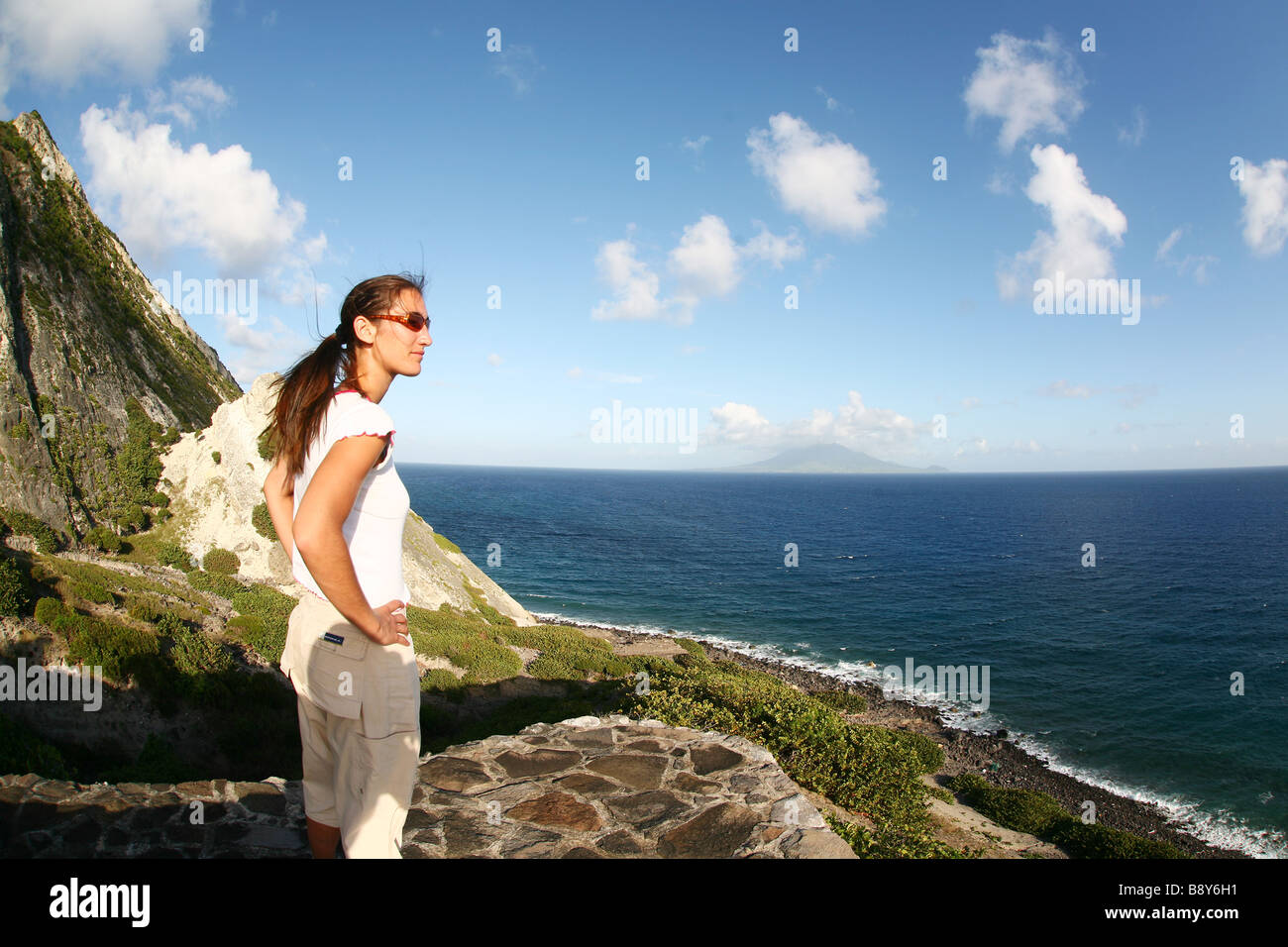 Woman looking out over the ocean on the Caribbean island Saint Eustace ...