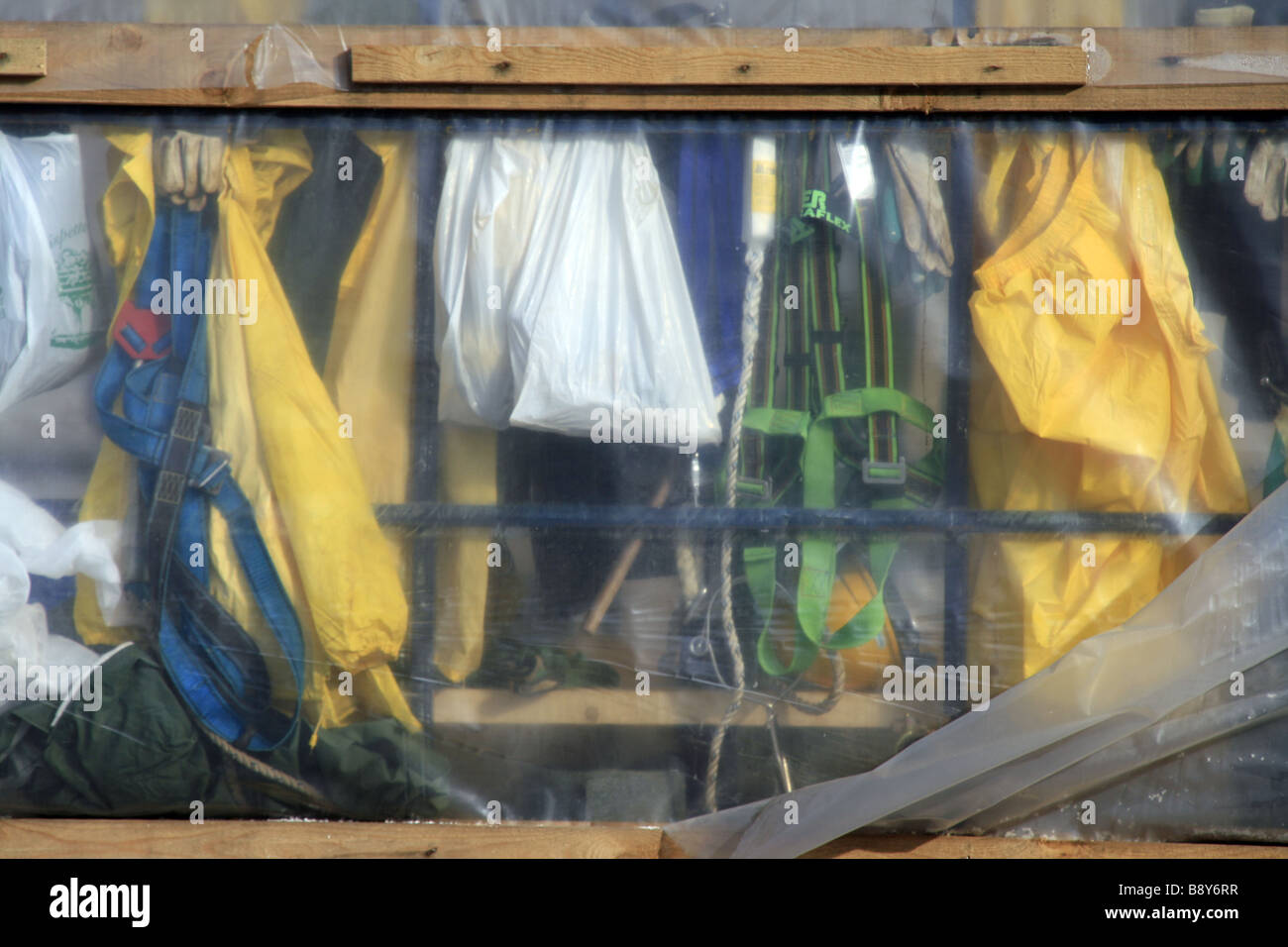 construction workers clothes and equipment hanging in makeshift ...