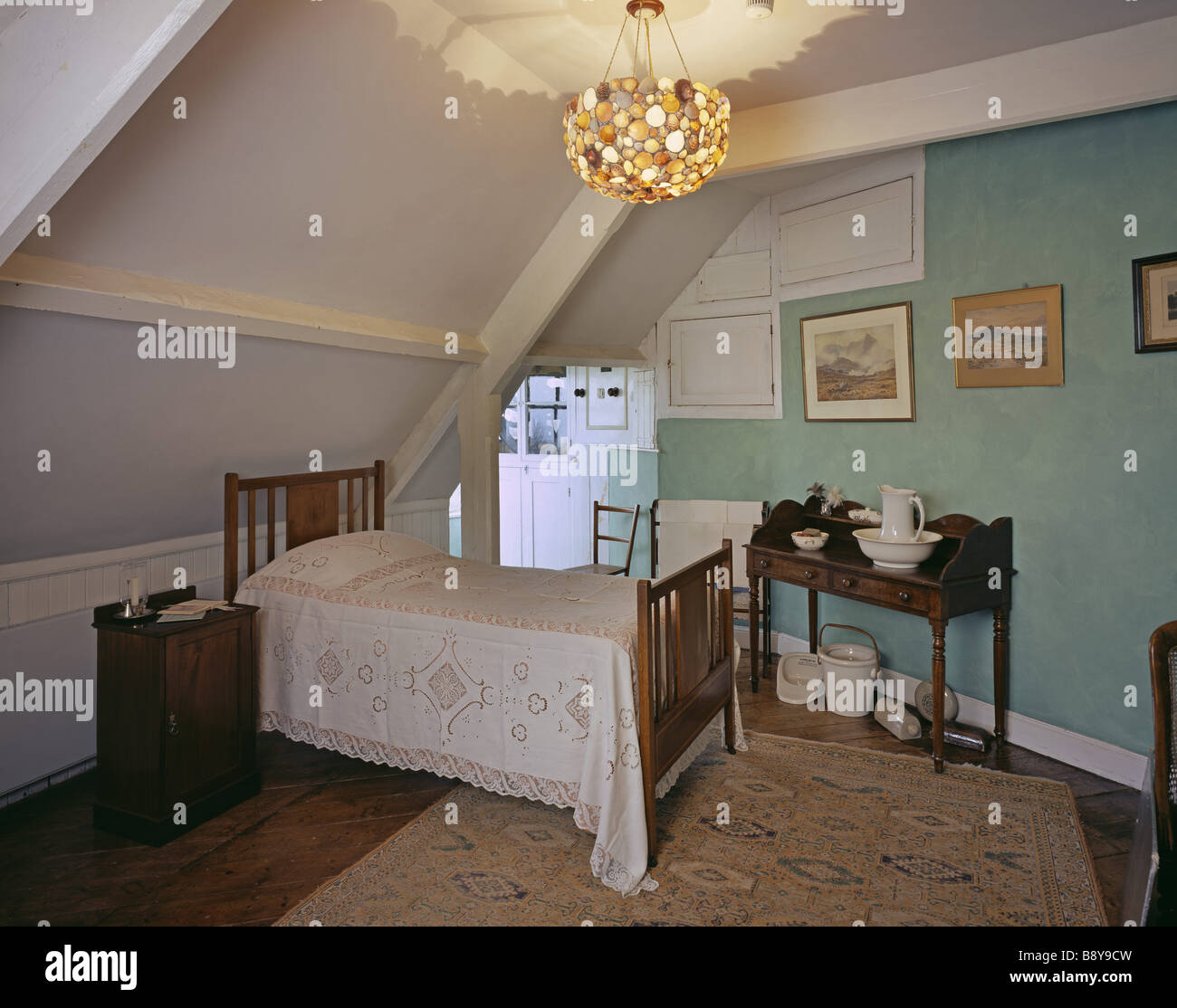 Second floor bedroom with shell lampshade Stock Photo - Alamy