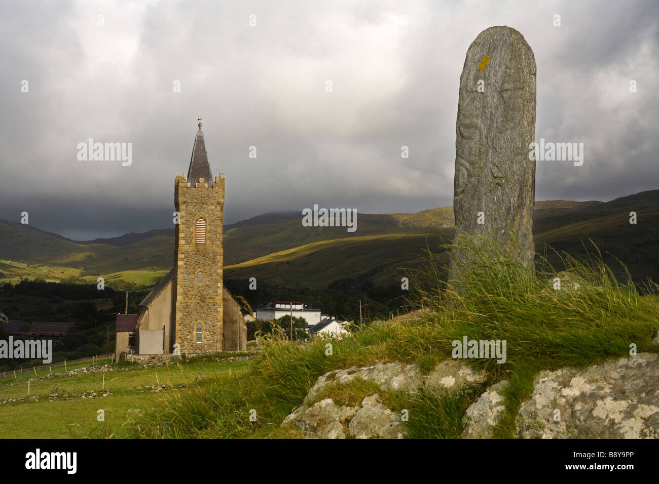 Standing stone with a church in the background, Glencolmcille, County ...