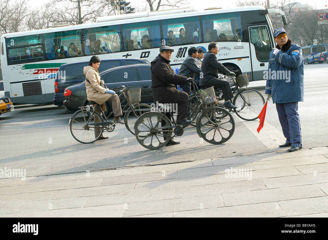 Chinese traffic conductor with red flag and whistle, five people on ...