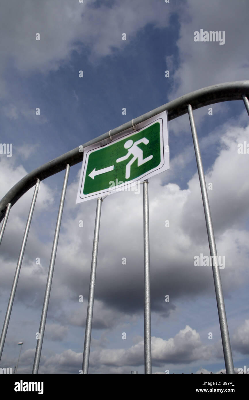 emergency exit sign on barrier fence outdoors Stock Photo - Alamy