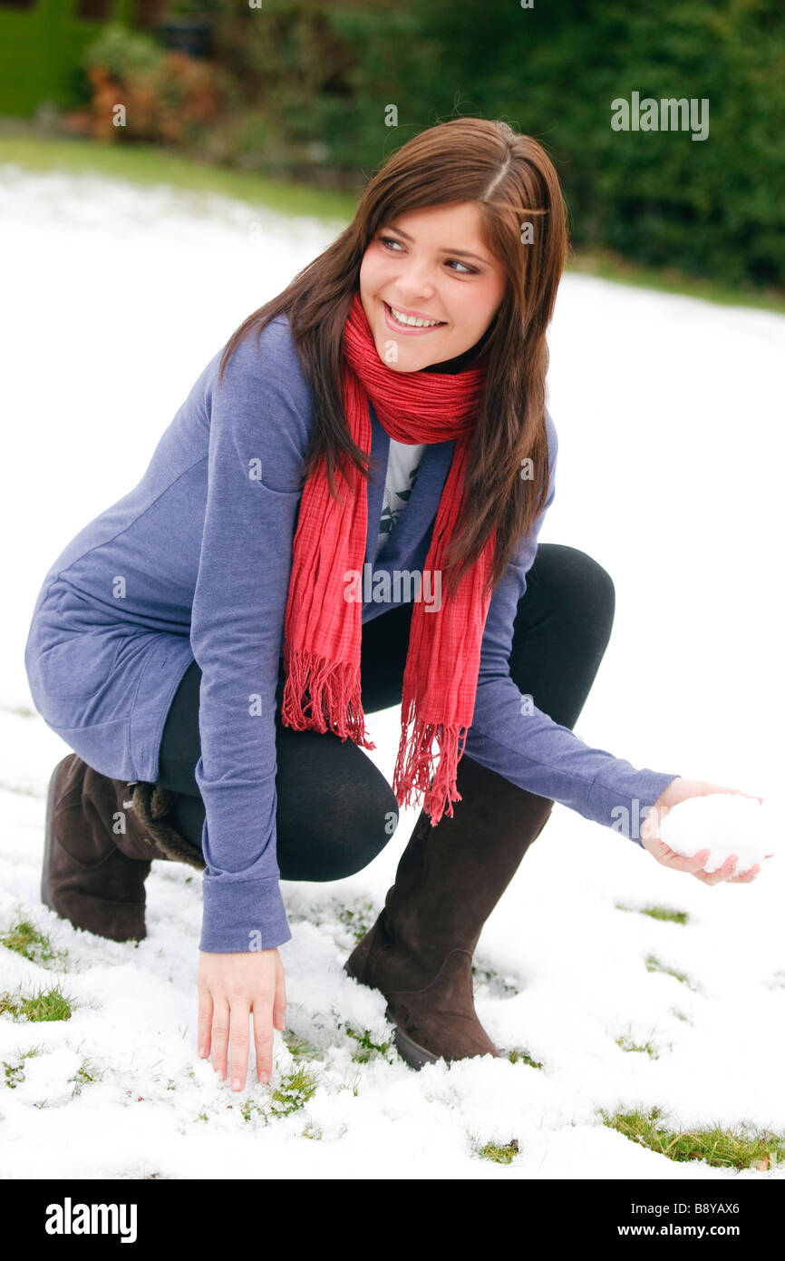 Girl throwing snowballs Stock Photo - Alamy