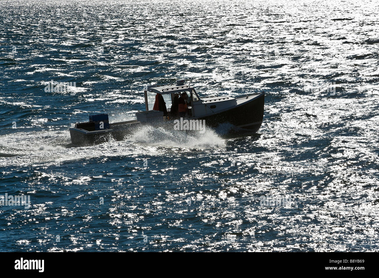 Fishing boat heading out to sea Stock Photo - Alamy