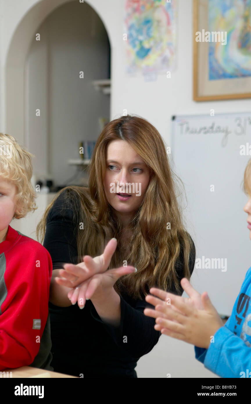 Teacher with children in a classroom Stock Photo - Alamy
