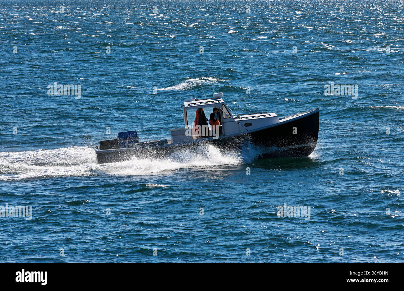 Fishing boat heading out to sea Stock Photo - Alamy