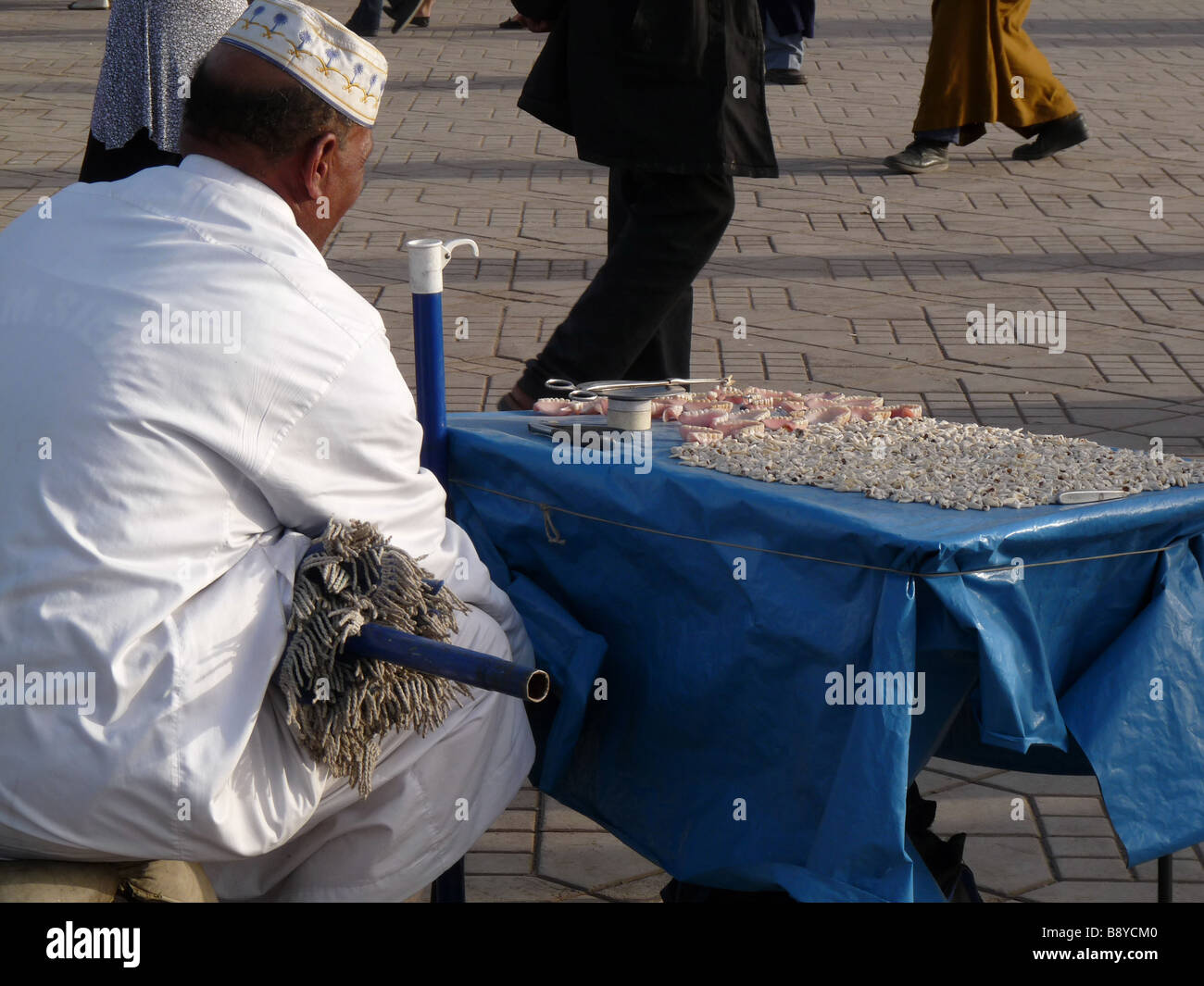 A Moroccan shopkeeper sells loose teeth and dentures at dusk in Djma el ...