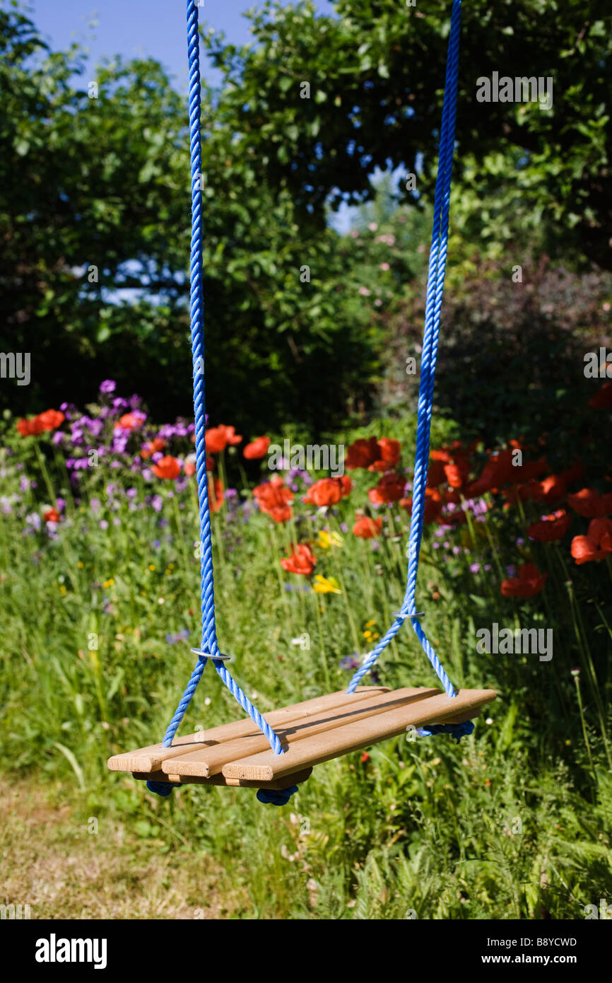 A swing in a flowery garden Sweden Stock Photo - Alamy
