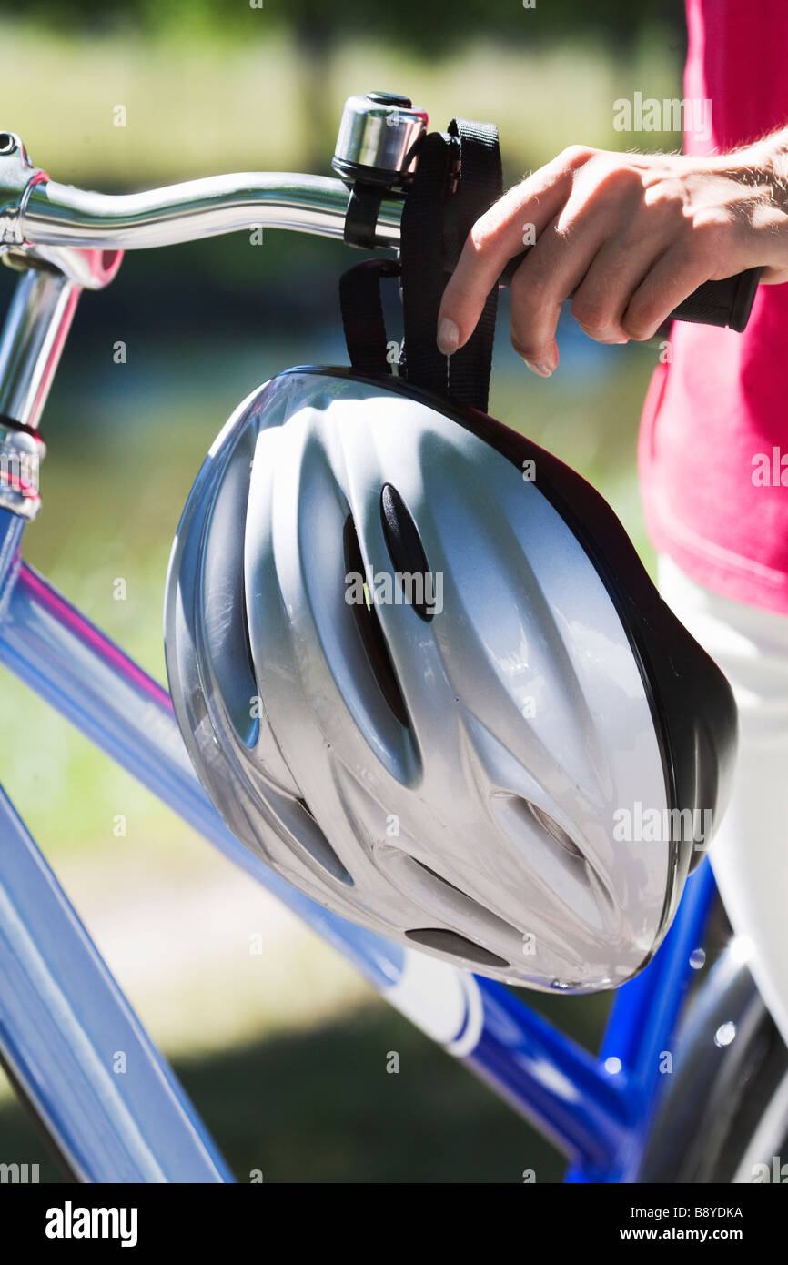 The hand of a young woman holding a bicycle Stock Photo - Alamy