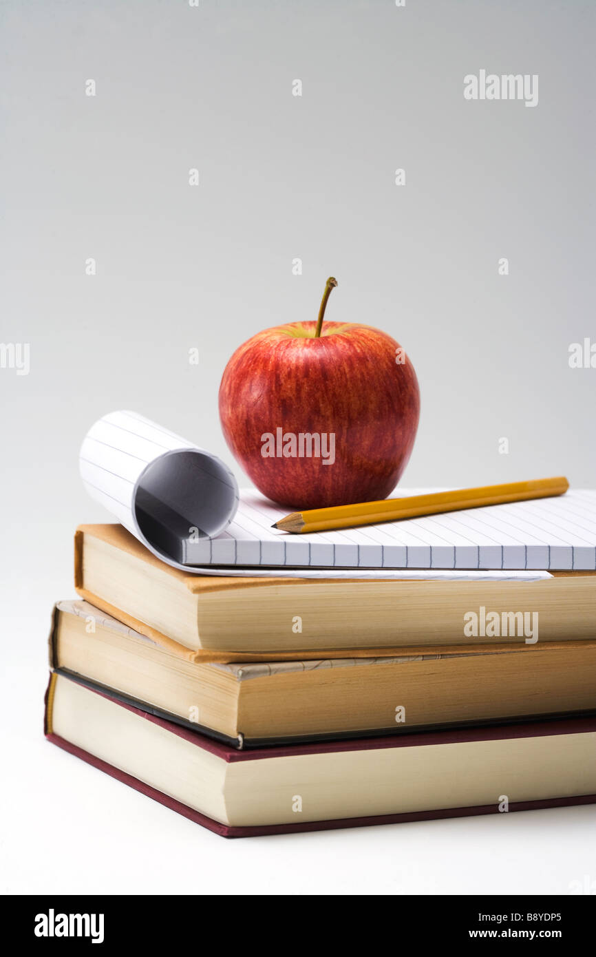 A red apple and books close-up Stock Photo - Alamy