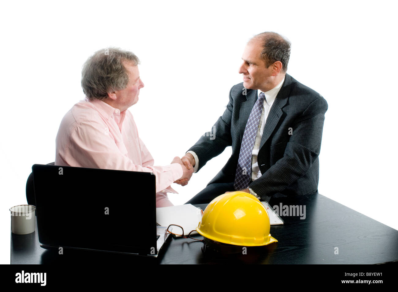 Two business senior executive partners shaking hands in office. Client ...