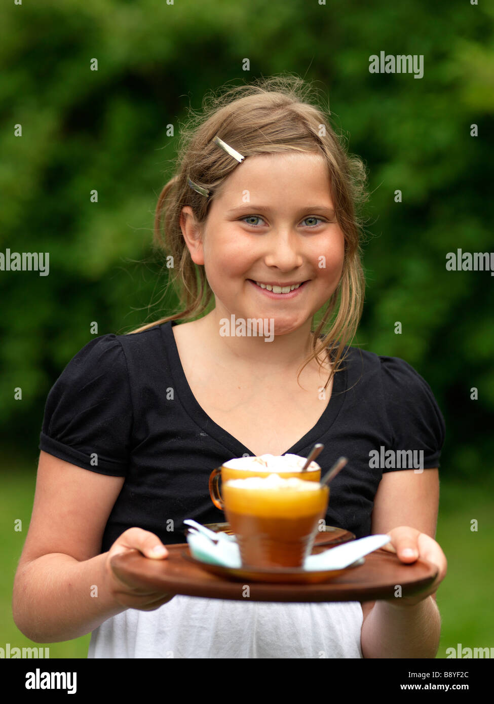 A girl carrying a tray with chocolate drinks Stock Photo - Alamy