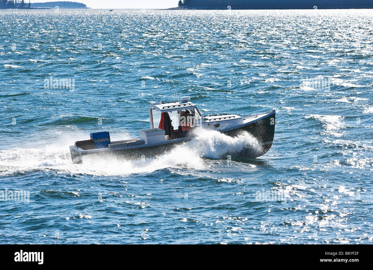 Fishing boat heading out to sea Stock Photo - Alamy
