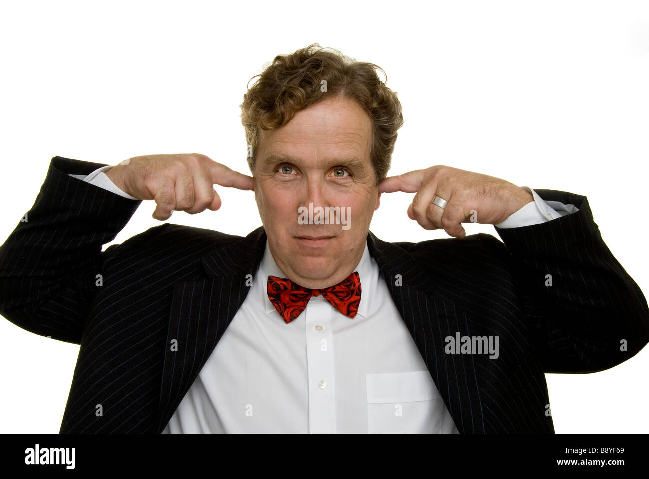 man with fingers in ears not listening Stock Photo - Alamy
