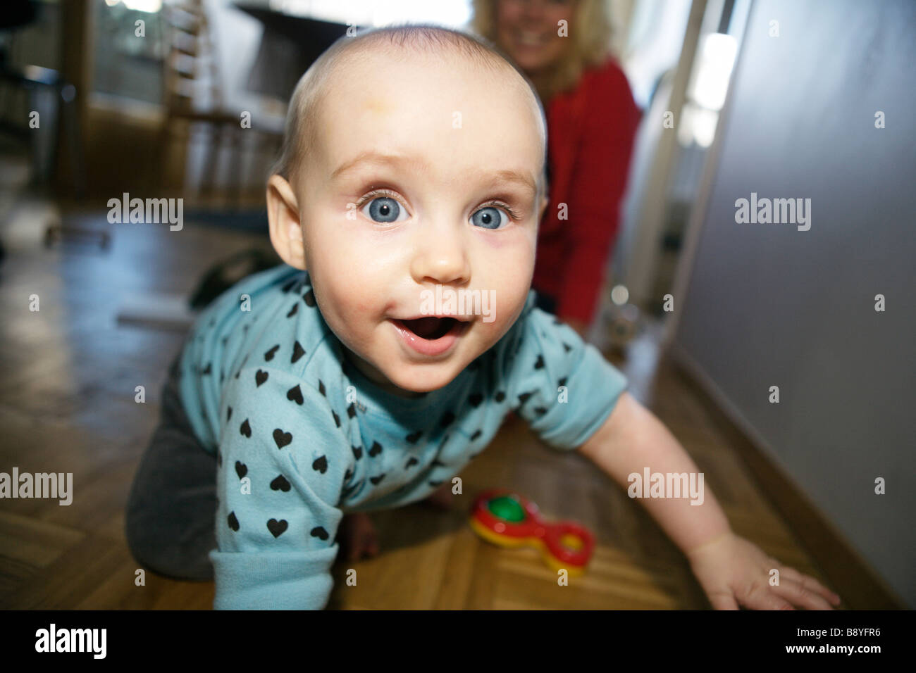 A girl crawling on the floor Sweden Stock Photo - Alamy